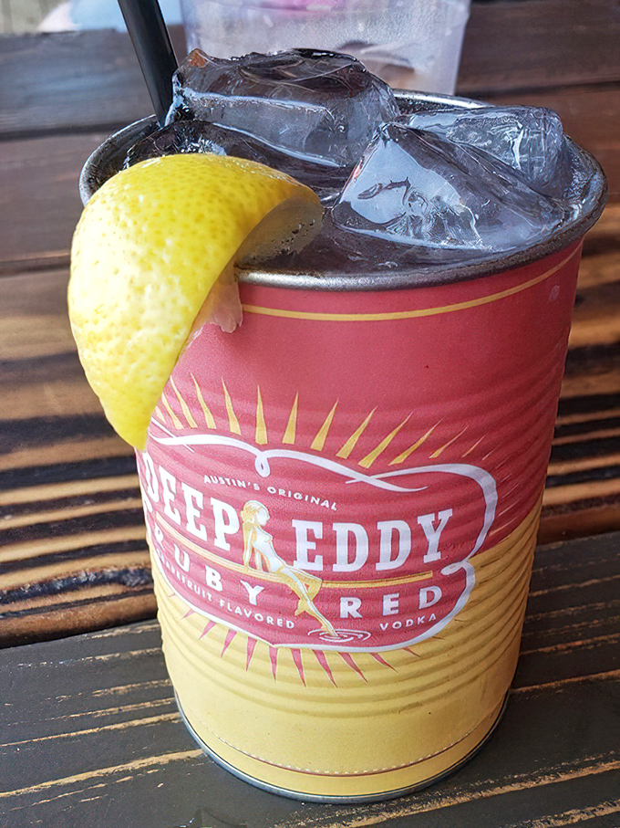 Deep Eddy's ruby red grapefruit vodka in a metal cup with a lemon wedge &ndash; Texas sunshine in liquid form.