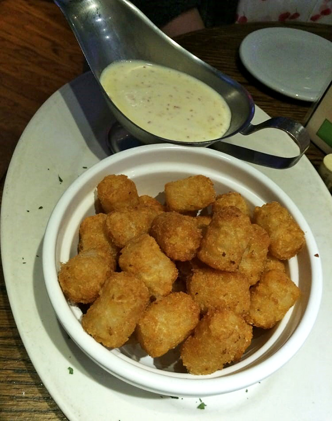 Golden tater tots with creamy dipping sauce&mdash;proof that childhood favorites can still bring joy to grown-ups who pay mortgages and understand tax forms.