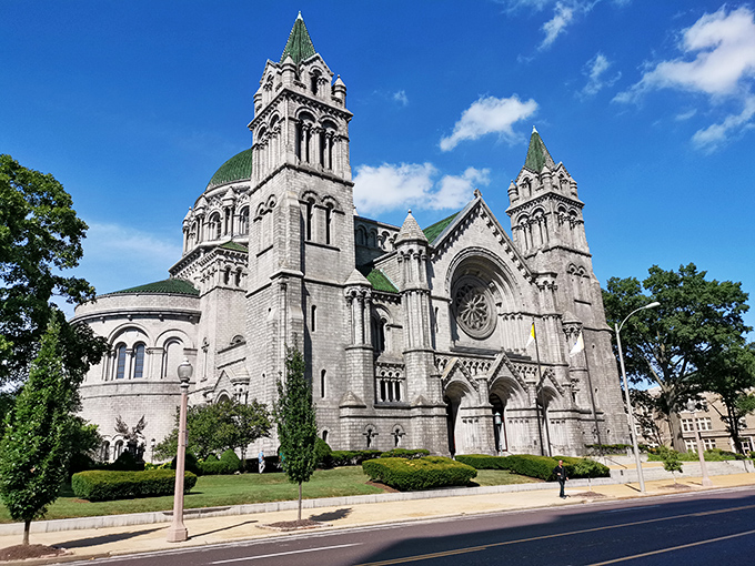 The Cathedral Basilica stands as a limestone testament to faith and craftsmanship, its twin spires reaching skyward like Gothic prayers made permanent.
