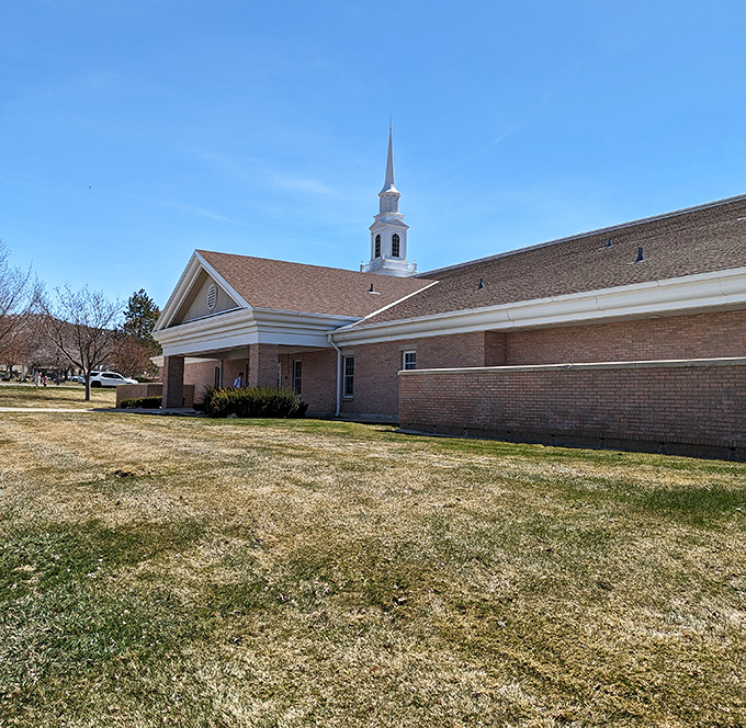The local church's steeple reaches skyward, a spiritual landmark as familiar to residents as the mountains themselves.