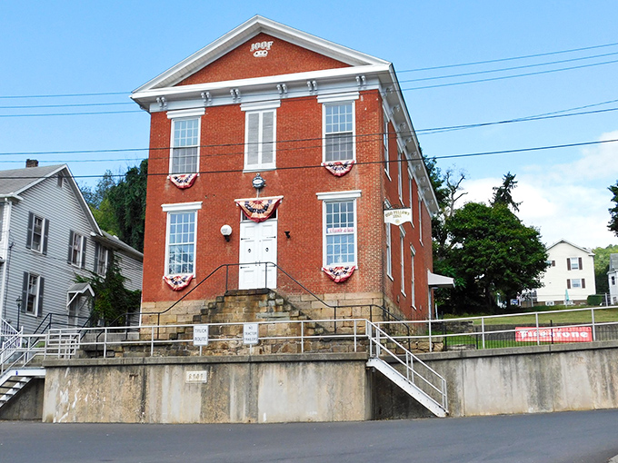 The historic IOOF Hall, dressed in patriotic bunting, represents the kind of architectural character developers spend millions trying to replicate in planned communities.