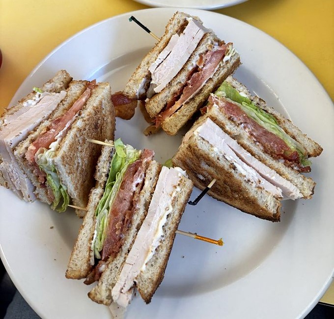 The turkey club: architectural marvel of the sandwich world, where each perfectly cut triangle deserves its own zip code.