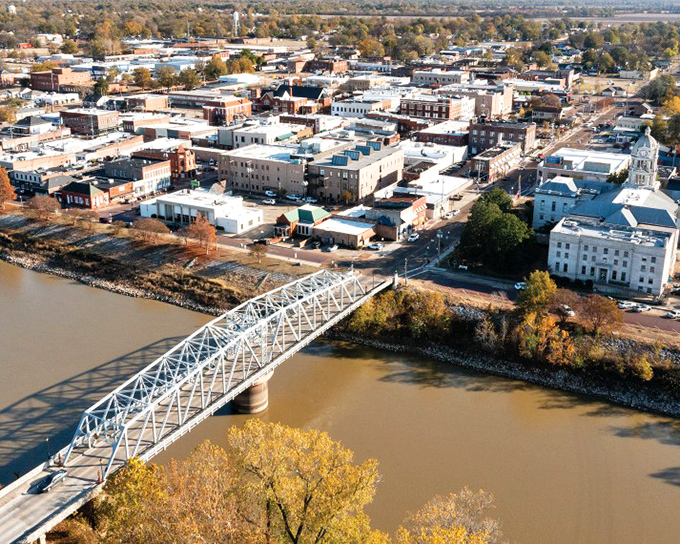 An aerial view reveals Greenwood nestled alongside the Yazoo River, with its downtown grid pattern as orderly as a well-planned retirement budget.