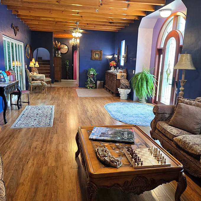 Navy walls and chess sets suggest this parlor is where strategy sessions happen between bouts of refined relaxation.