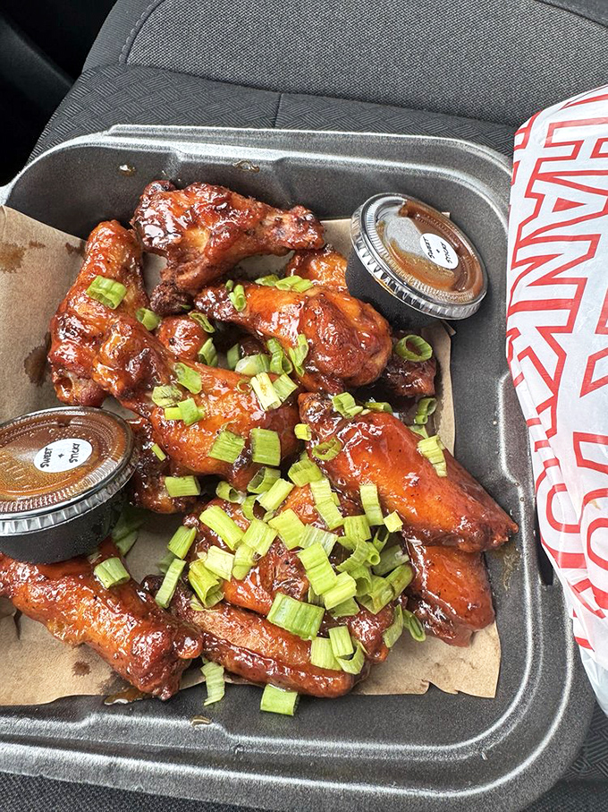 These wings aren't just glazed—they're lacquered with sticky-sweet sauce and green onions. Car eating required; shirt protection highly recommended.