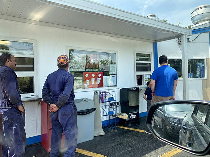 The window of opportunity&mdash;where dreams are ordered and handed back wrapped in paper. These workers aren't just making food; they're crafting memories.