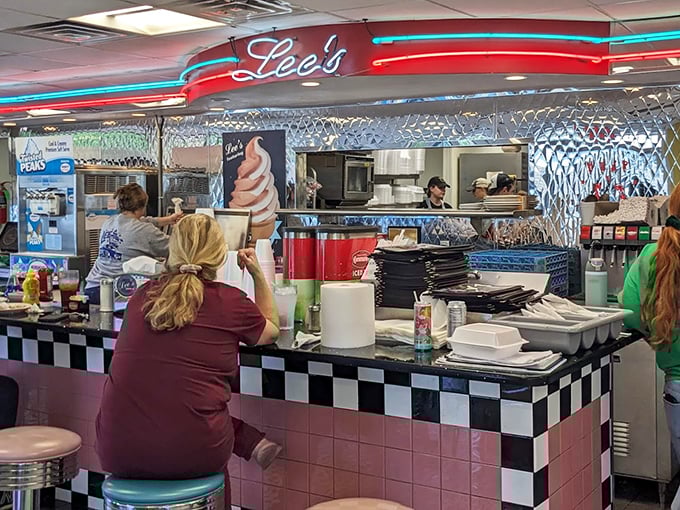 At the counter, where regulars perch on pink stools, waitresses orchestrate the breakfast ballet with coffee pots as their batons.