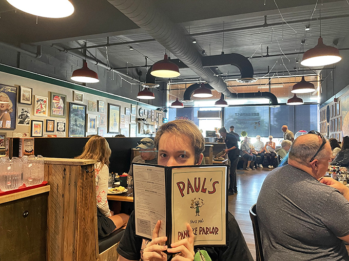 Where locals and visitors become temporary breakfast companions. That menu-hiding moment when you're contemplating all the delicious possibilities.