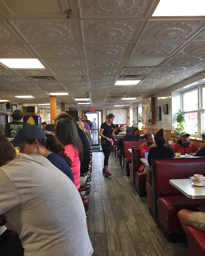 Where hungry travelers and locals converge in red vinyl booths under the watchful eye of those ornate ceiling tiles.