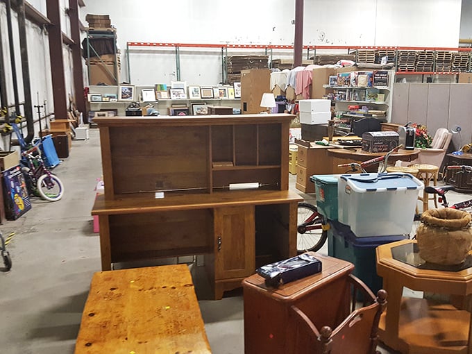Furniture purgatory or decorator's paradise? This back room holds solid wood pieces waiting for someone to recognize their potential beneath the dust.