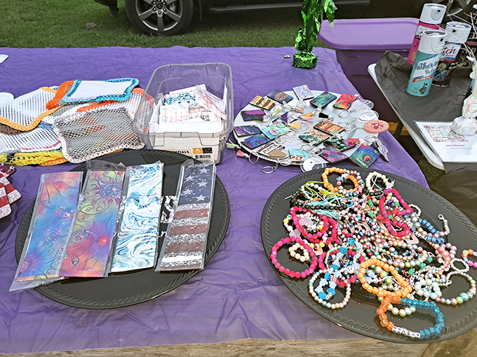 Handcrafted jewelry and accessories spread across purple fabric&mdash;each piece telling the story of its creator's imagination and skilled hands.