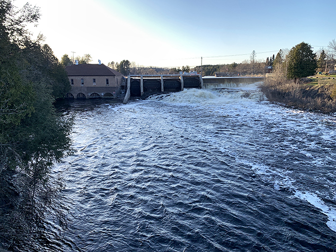 Nature's power harnessed at the Paint River dam, where rushing waters have powered this community for generations while providing a mesmerizing backdrop.