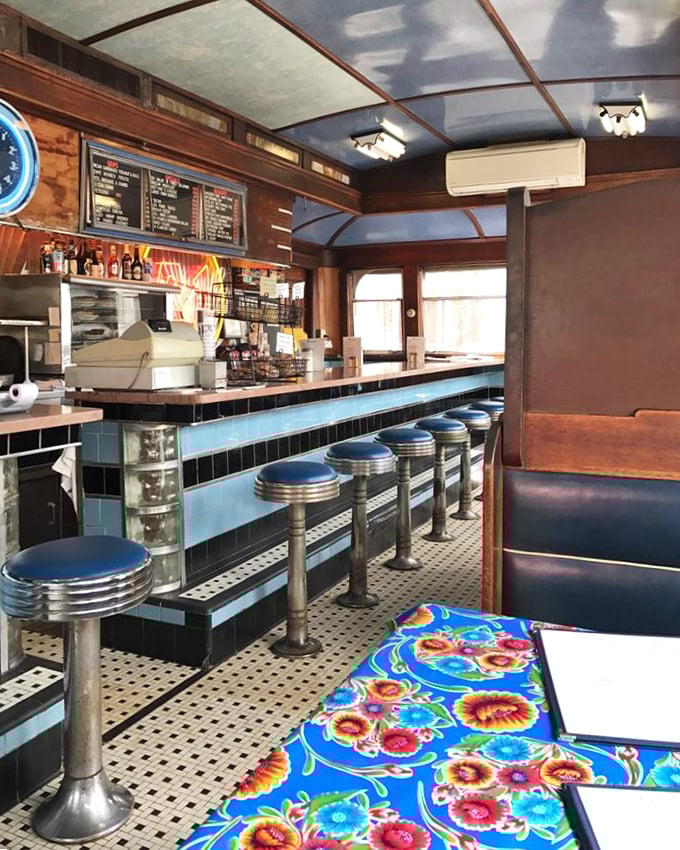 Blue stools against blue tiles &ndash; a color scheme that says "classic American diner" with the confidence of someone who's been in business for decades.
