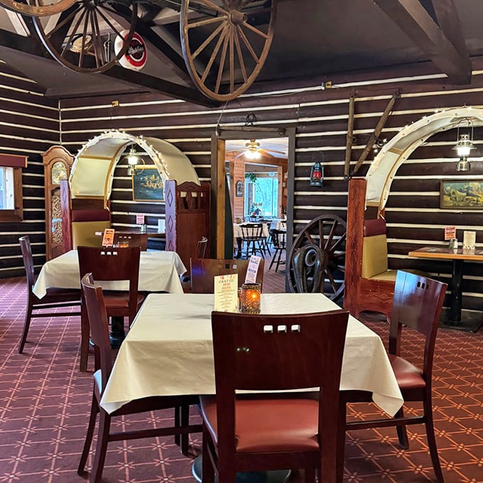 Wagon wheel arches frame the dining room like portals to a time when dinner was an event, not just a meal. The log walls have heard decades of "pass the butter" requests.