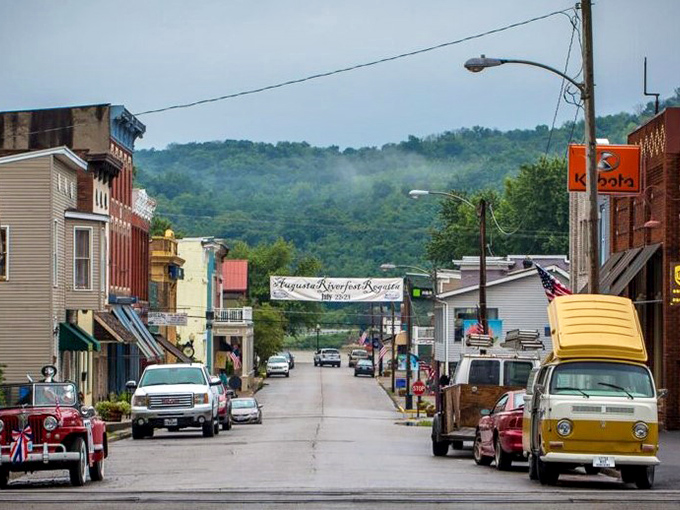 Main Street stretches toward the hills beyond, vintage vehicles and colorful storefronts creating a scene straight out of a nostalgic postcard.
