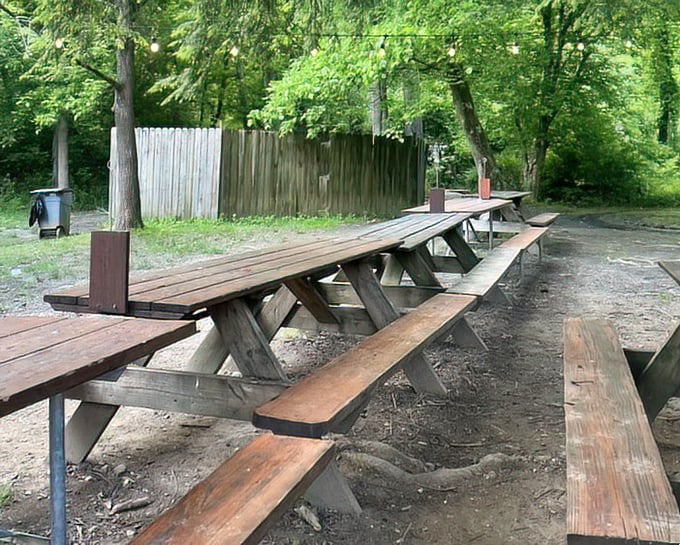 These picnic tables have heard more climbing stories than a mountain guide's therapist. Each weathered plank holds secrets of adventures past.
