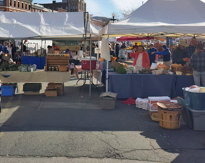 The outdoor market creates a temporary village square where conversations flow as freely as the coffee from nearby stands.