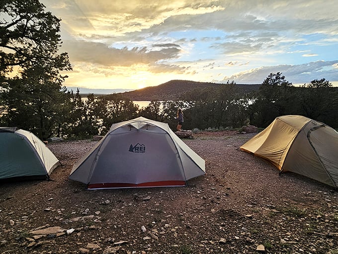 Sunset camping—where nature's light show outperforms Vegas, and tent real estate offers better views than penthouse apartments.