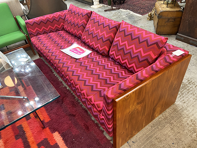 That sofa isn't just red; it's a technicolor dream machine straight from the grooviest corner of the 1970s.