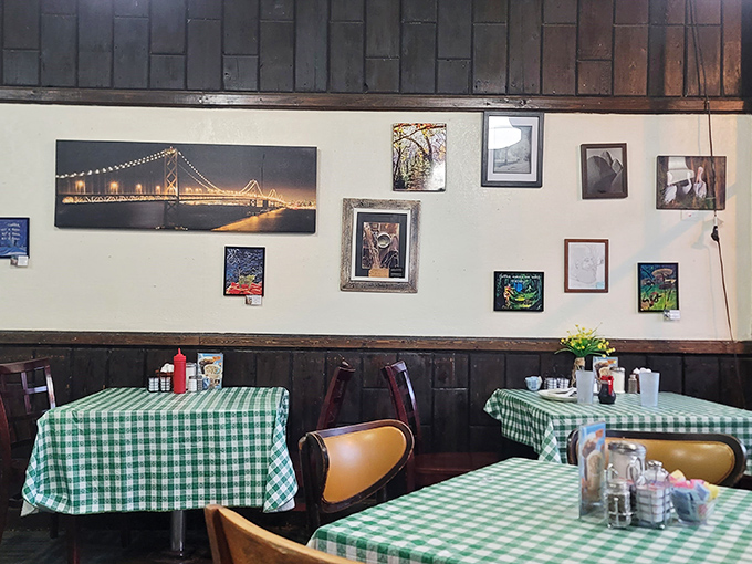 Dark wooden walls adorned with local art create the perfect backdrop for morning conversations that range from weather to world affairs. Every table has a story.