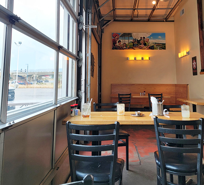 Large windows flood the dining area with natural light, creating a welcoming space where the only thing that matters is the plate before you.