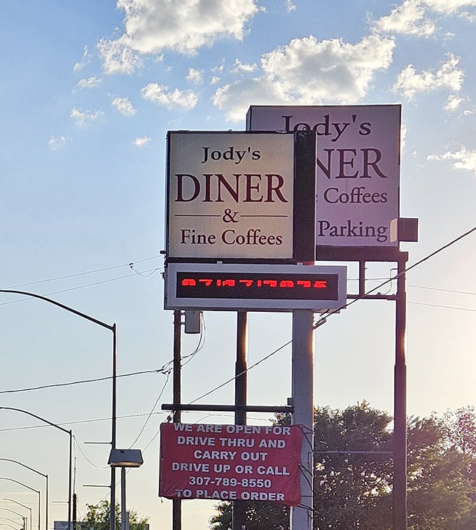 The roadside sign stands tall against Wyoming's big sky, a beacon for hungry travelers and truckers alike – "Fine Coffees" is no empty promise.