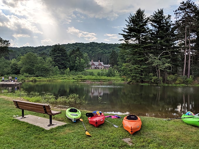 Kayaks waiting patiently for their next adventure. Each colorful vessel promises a different perspective on the park's stunning Tudor-style lodge.