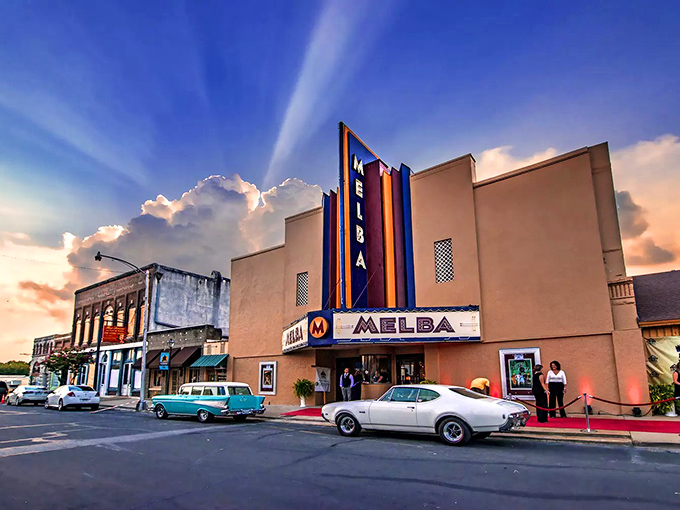 The Melba Theater in Batesville glows with vintage neon against a dramatic sunset. This isn't just a movie house&mdash;it's a time machine with reasonable ticket prices!