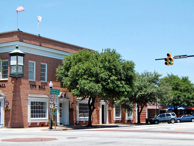 Hartsville City Hall stands proudly on Fifth Street, shaded by leafy trees under a bright blue sky.