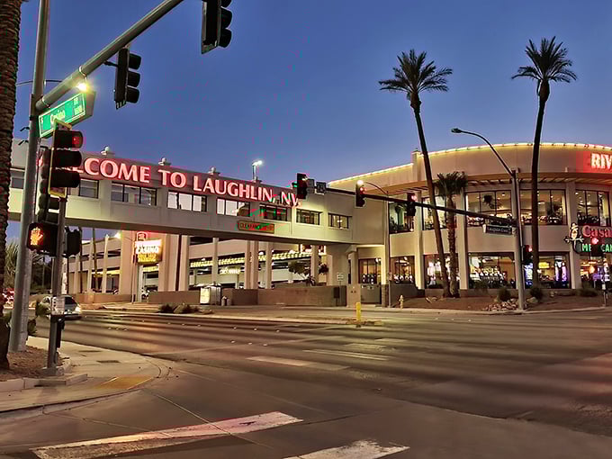 Laughlin's neon welcome sign glows against the desert night, promising riverside fun without the Vegas crowds or prices. Jackpot!