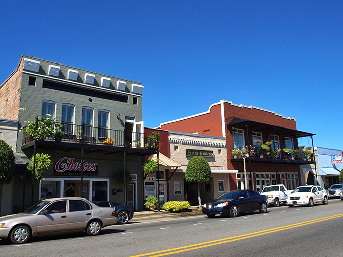 Colorful storefronts with second-floor balconies give Atmore's downtown a New Orleans-meets-Main-Street vibe under brilliant Alabama blue skies.