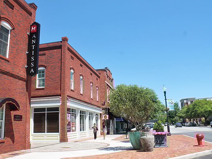 Hartsville's charming downtown features historic brick buildings, including Mantissa restaurant, with brick sidewalks and colorful planters.