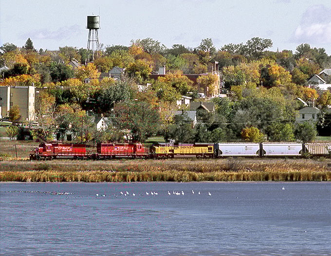 A freight train rolls past Kenmare's tree-lined neighborhoods, where affordable homes and peaceful living go hand in hand perfectly.