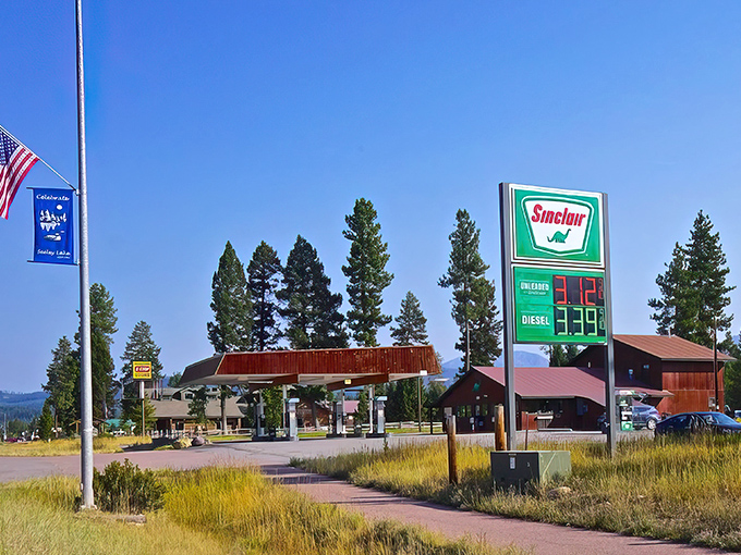 The Sinclair dinosaur sign stands as a cheerful landmark in Seeley Lake, where gas stations double as community gathering spots.