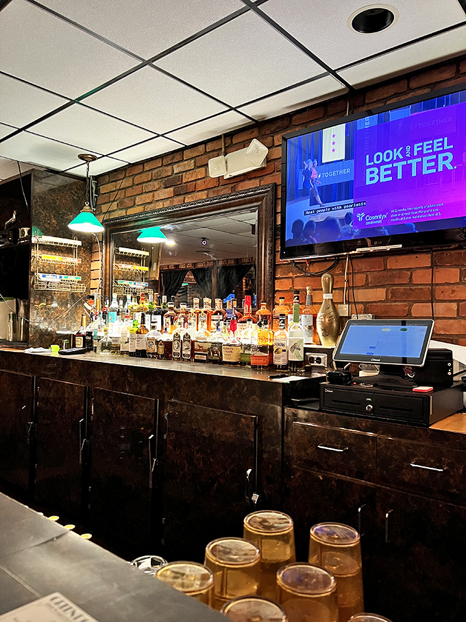 A well-stocked bar ready to complement your slider adventure. The golden horse trophy watches approvingly over your beverage choices.