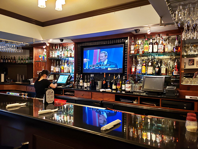 The bar area—where strangers become friends over Chianti and debates about which sauce reigns supreme.