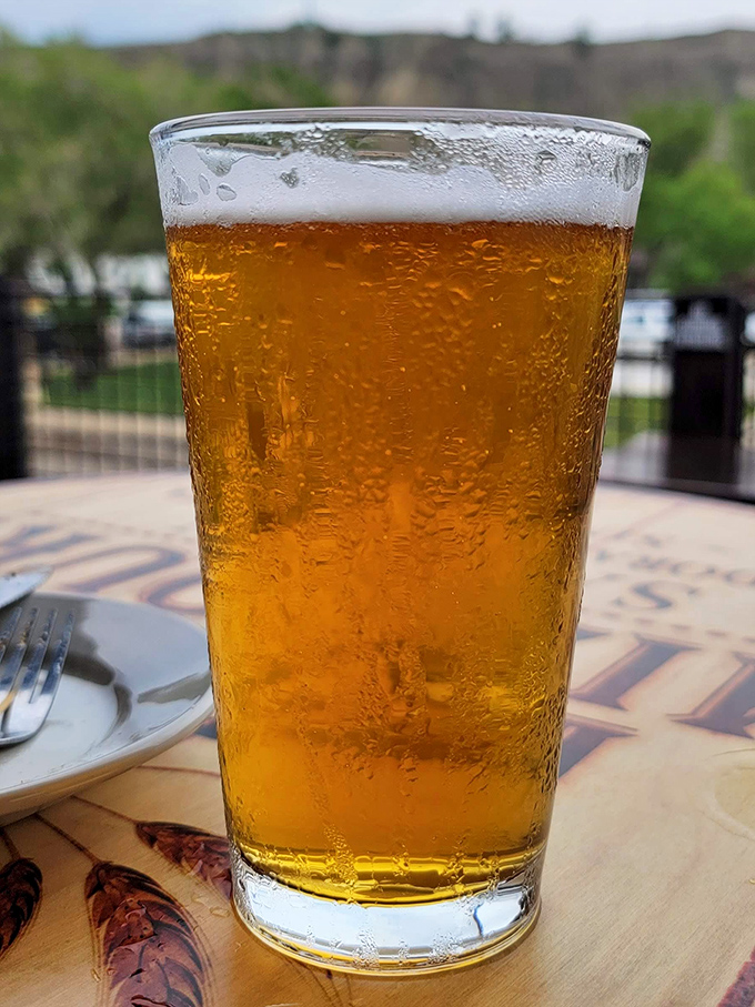 A cold beer with condensation beading down the glass&mdash;nature's way of saying "You've earned this" after a day exploring Theodore Roosevelt National Park.