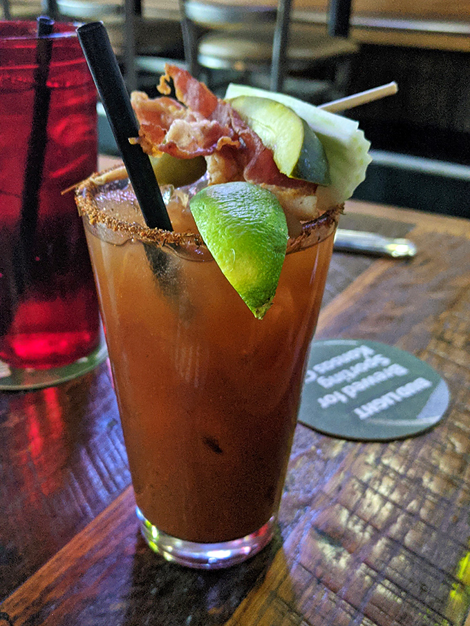 This isn't just a Bloody Mary; it's a meal in a glass with bacon and lime that says "brunch can happen anytime."