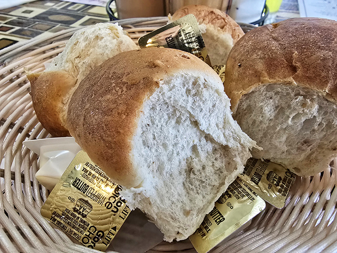 Fresh bread arrives in a basket, still warm and ready to soak up every last drop of gravy.