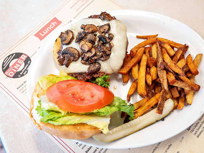 A mushroom-topped burger that whispers "forget your diet" with every bite, accompanied by hand-cut fries that put fast food spuds to shame.
