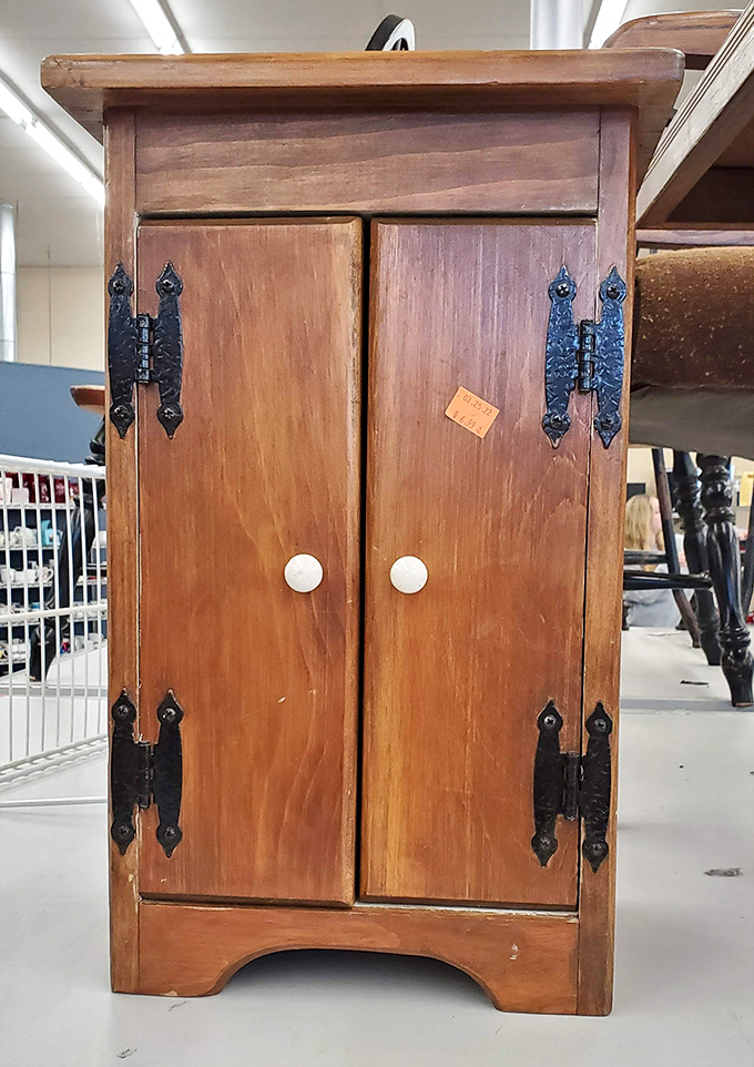 This charming wooden cabinet whispers "take me home" with its vintage hardware and endless possibilities for storage or display.