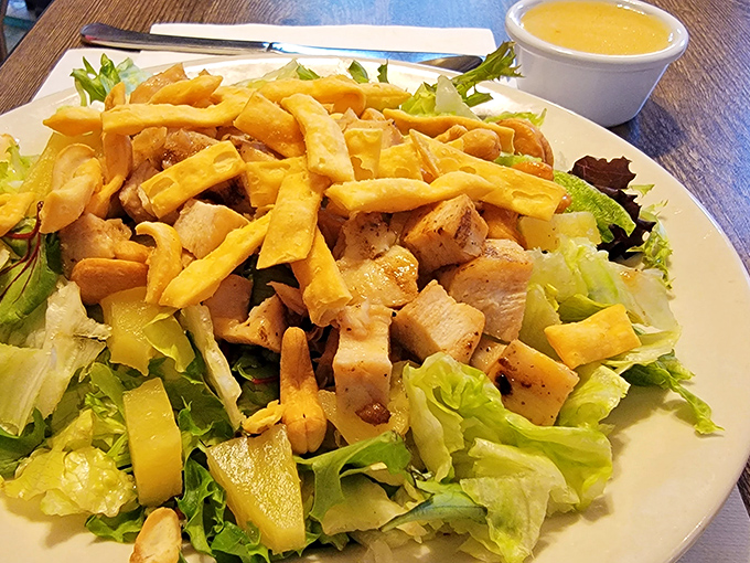 A salad that doesn't feel like punishment. Crisp greens, tender chicken, and those golden fries make healthy-ish feel like an indulgence.