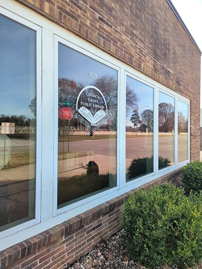 Books and community knowledge shine behind these windows, where the Council Grove Library has served curious minds for generations.