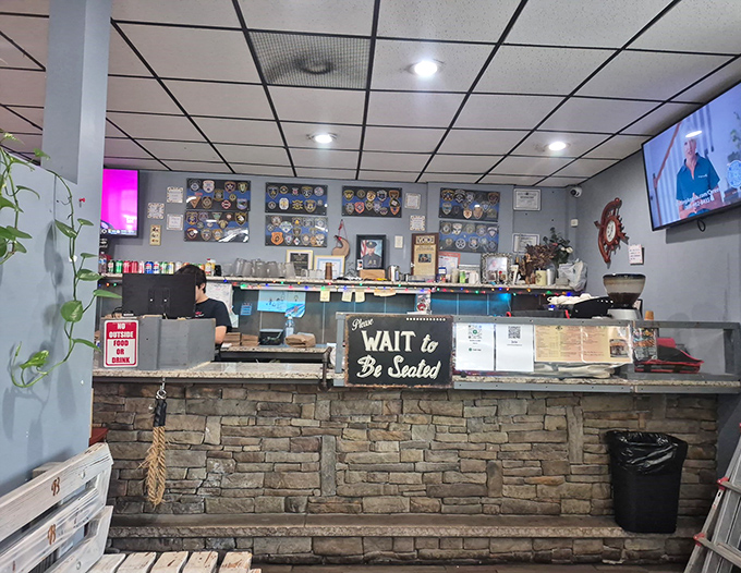"Please Wait to Be Seated" says the sign, but the aromas make patience a genuine virtue. The counter where barbecue dreams begin.
