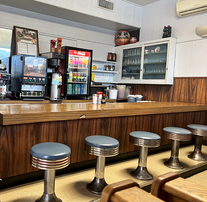 The counter seating—where solo diners become regulars and the staff eventually knows your order before you sit down.