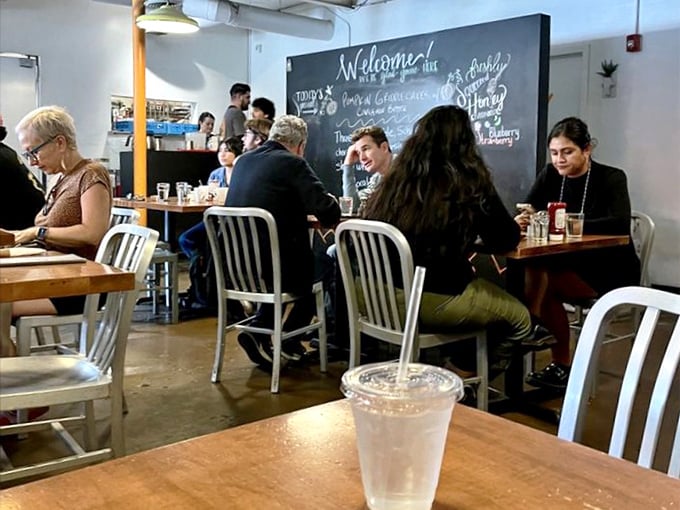 The dining room buzzes with the energy of happy eaters, while the chalkboard wall reminds you this is a place that takes food seriously, not itself.