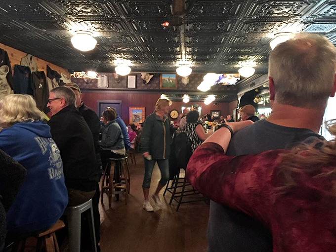 The bar area buzzes with the kind of genuine conversation that happens when phones get forgotten and stories take center stage.