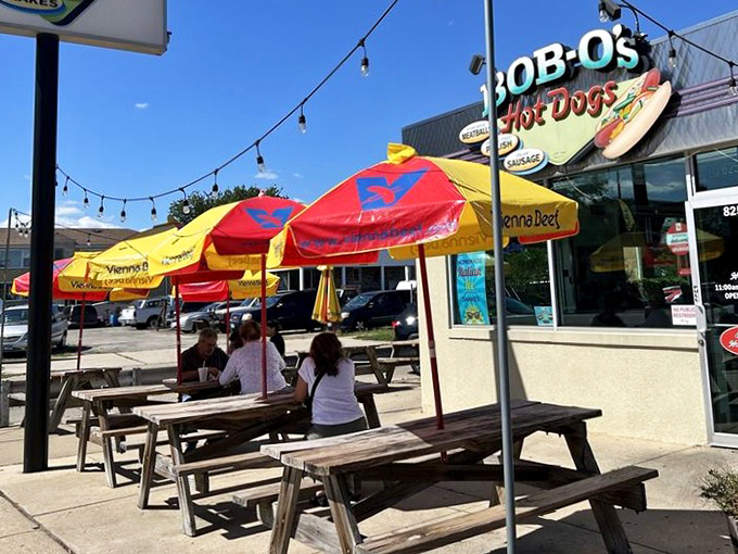 Those colorful umbrellas aren't just for show—they're beacons guiding hungry pilgrims to the promised land of proper Chicago street food.