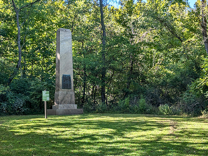 The Edward Orton Monument stands as a silent sentinel in a clearing, commemorating history while surrounded by the timeless forest.