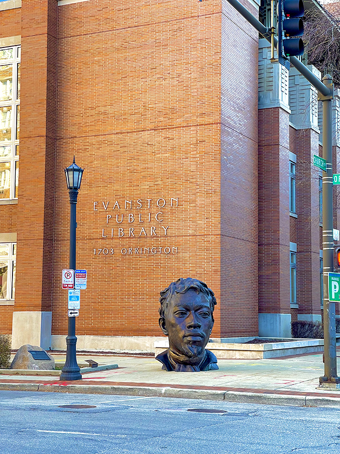 Outside the Evanston Public Library, a bronze bust keeps silent watch, perhaps contemplating which classic novel visitors might discover inside these brick walls.